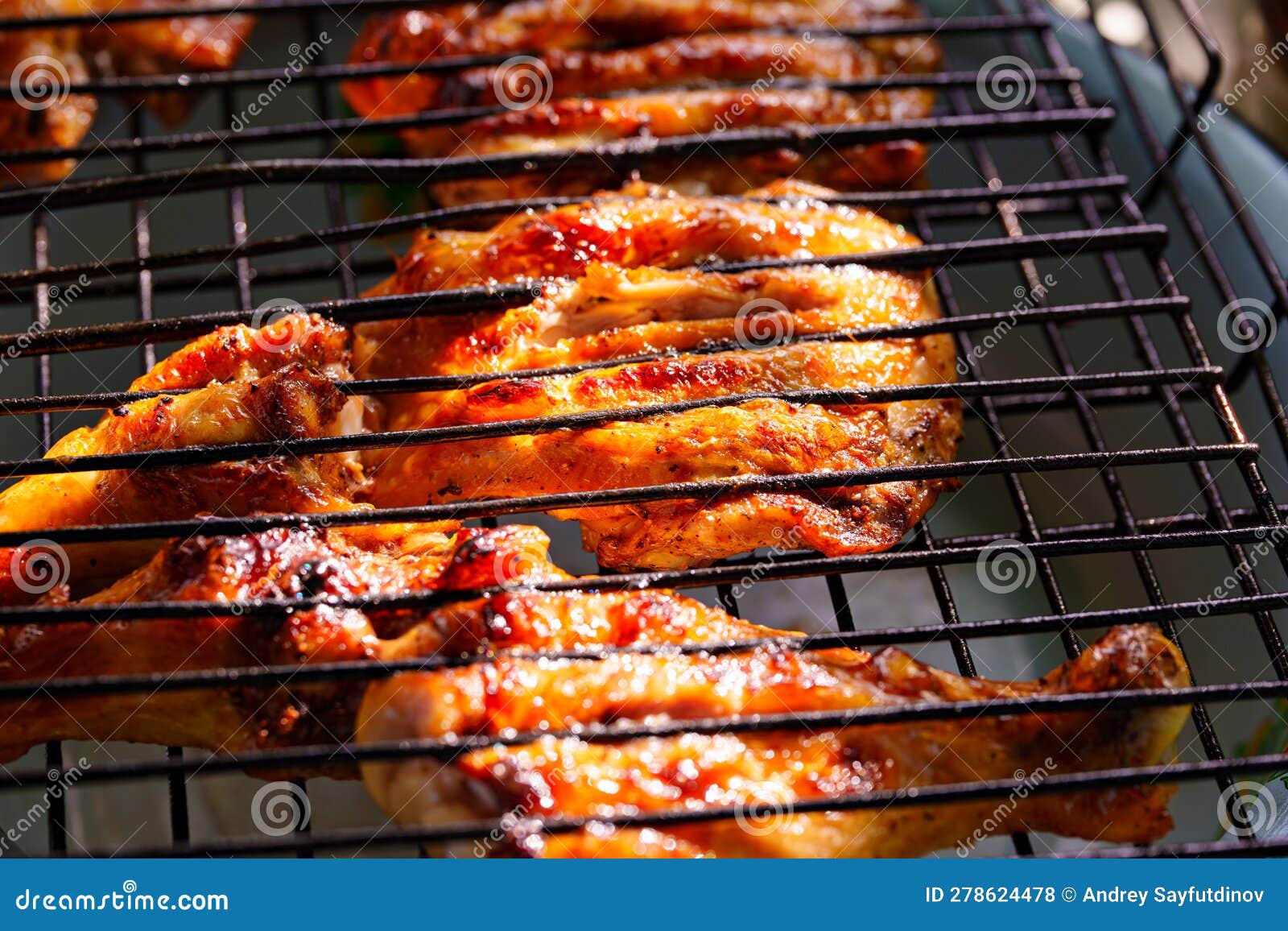 Close-up. Chicken Steaks on a Grill Rack Cooking Over an Open Fire ... Close-up. Chicken Steaks on a Grill Rack Cooking Over an Open Fire ...
