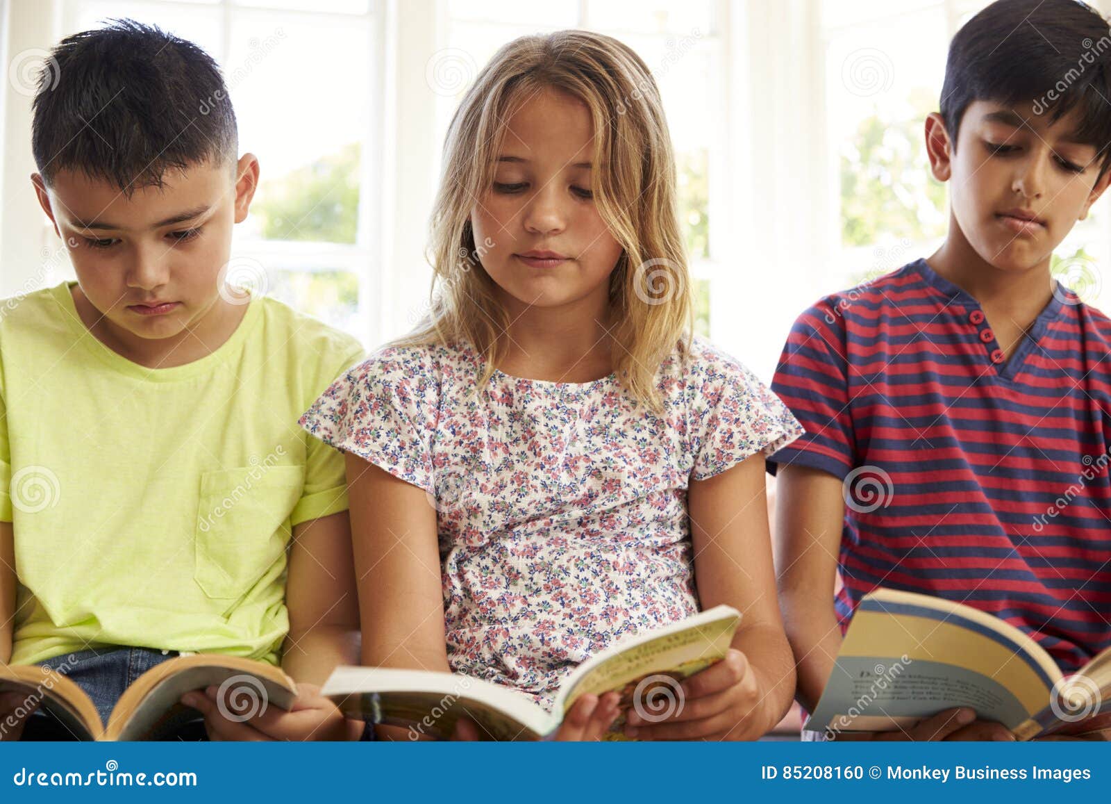 Close Up of Children Reading on Window Seat Stock Photo - Image of ...