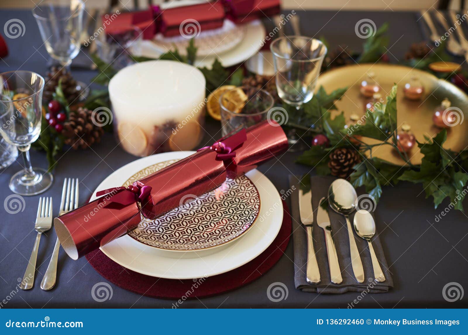 Close Up of Christmas Table Setting with Crackers Arranged on Plates ...