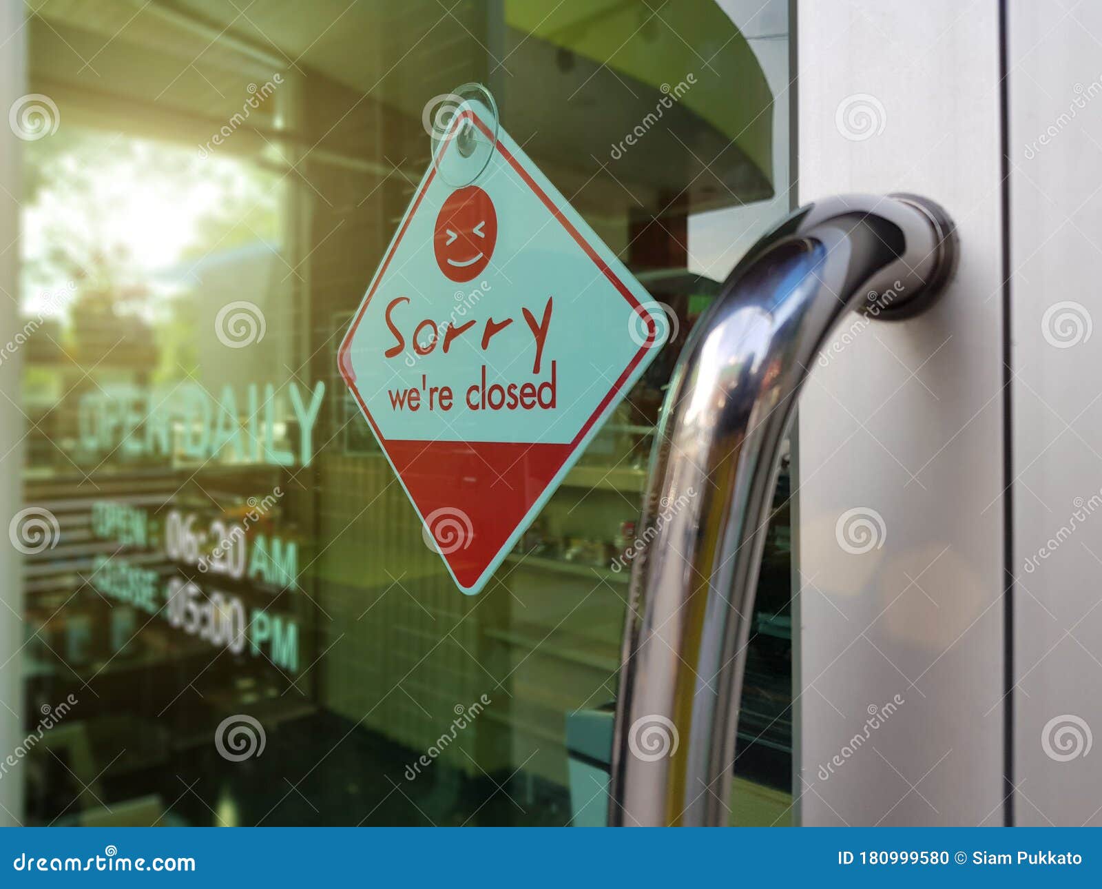 Close-up on a Closed Sign in the Window of a Shop with Text Sorry we ...