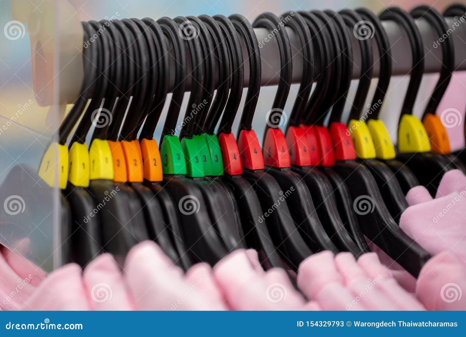 Close Up of a Clothing Rack with Hangers Showing Different Clothing ...