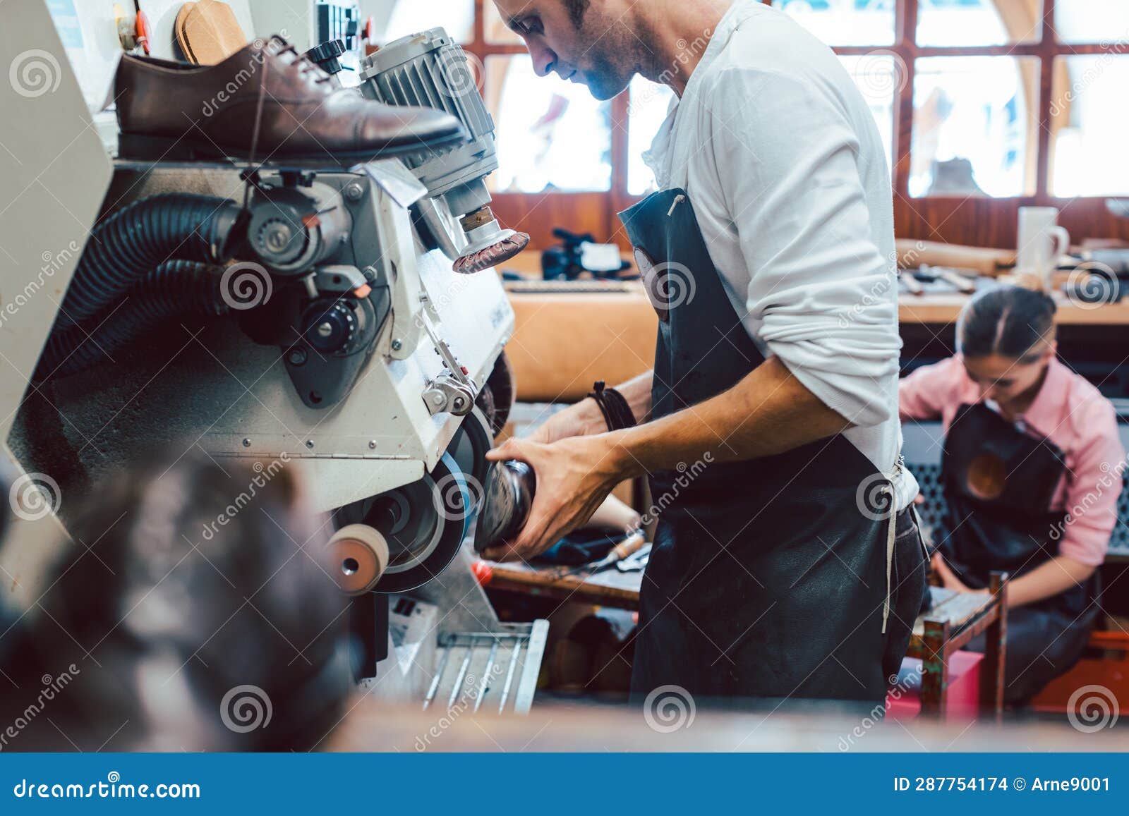 Close-up of Cobbler Working on Pair of Shoes with Machine Stock Photo ...