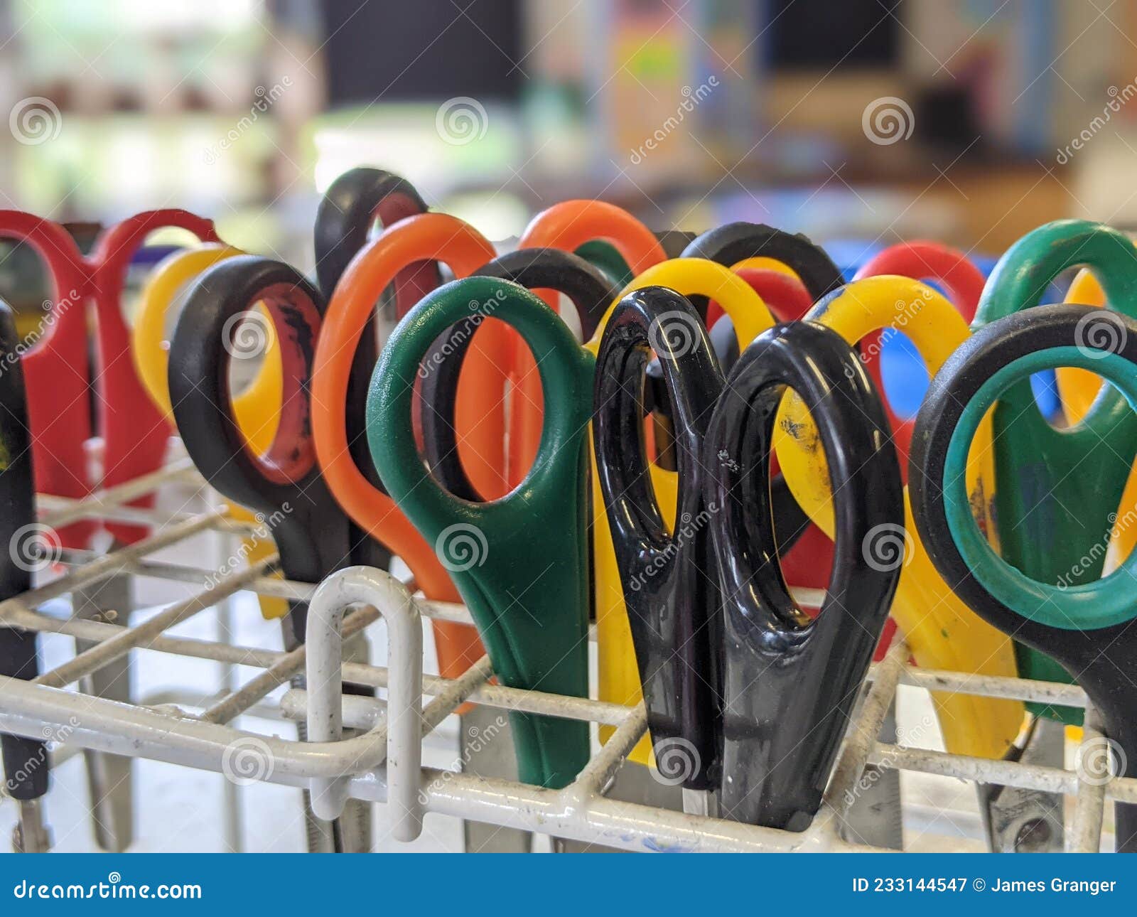 A Close Up of a Collection of Classroom Scissors Handles in a Rack ...