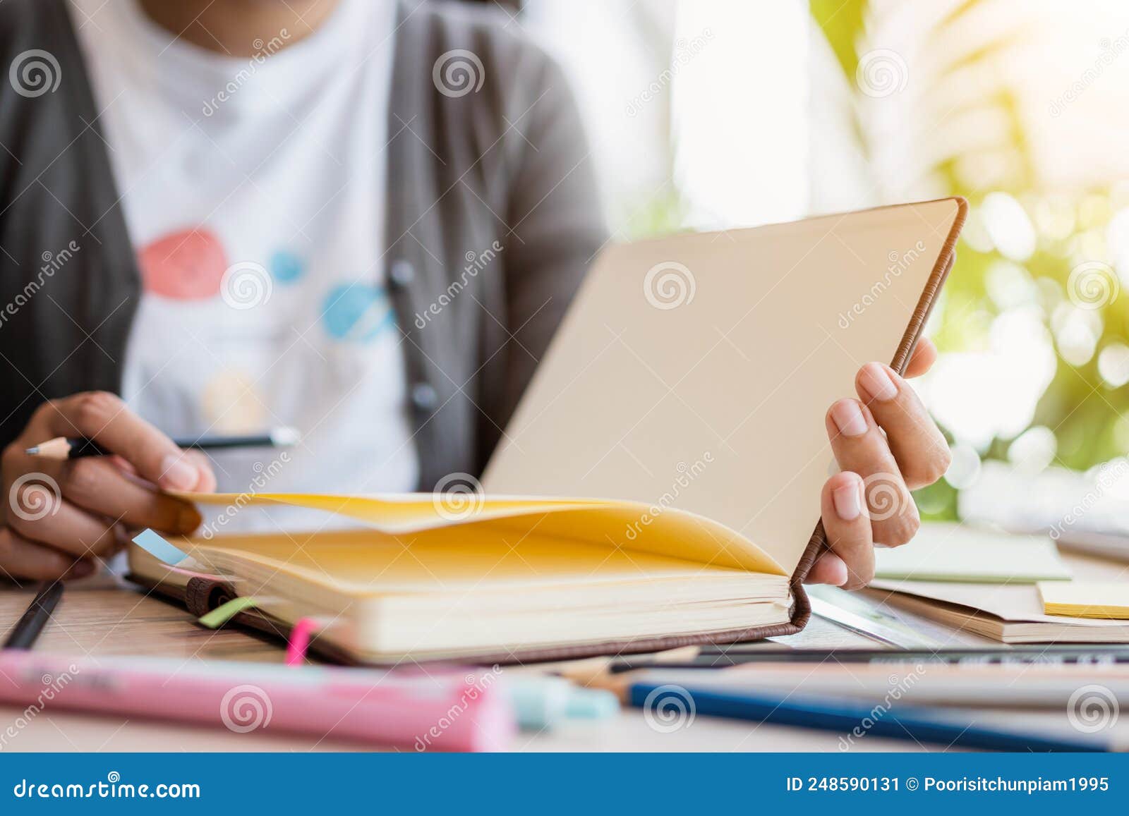 Close Up of College Student Hands Open Notebook for Writing Something ...