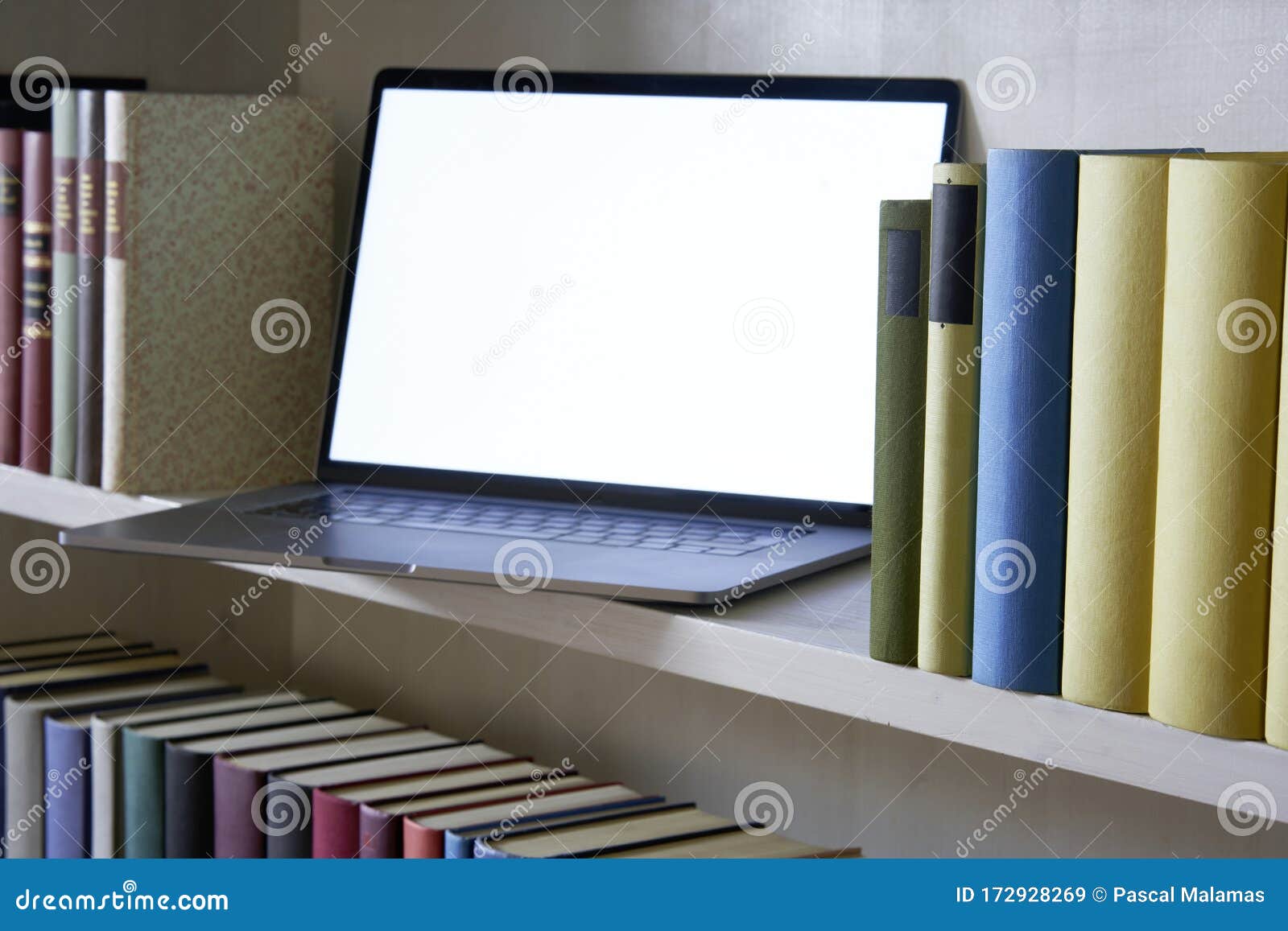 Close Up of Computer in Bookcase Stock Image - Image of display ...
