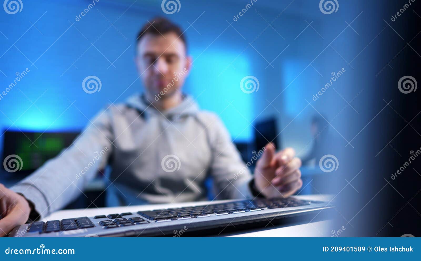 Close-up of Computer Keyboard with Blurred Nervous Caucasian Man Typing ...