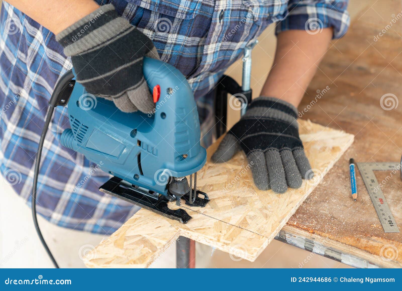 Close Up Construction Worker Hands Using Electric Jig Saw for Cutting ...