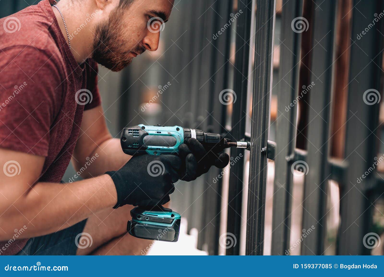 Construction Worker Using Screwdriver and Drilling Screws into Metal ...