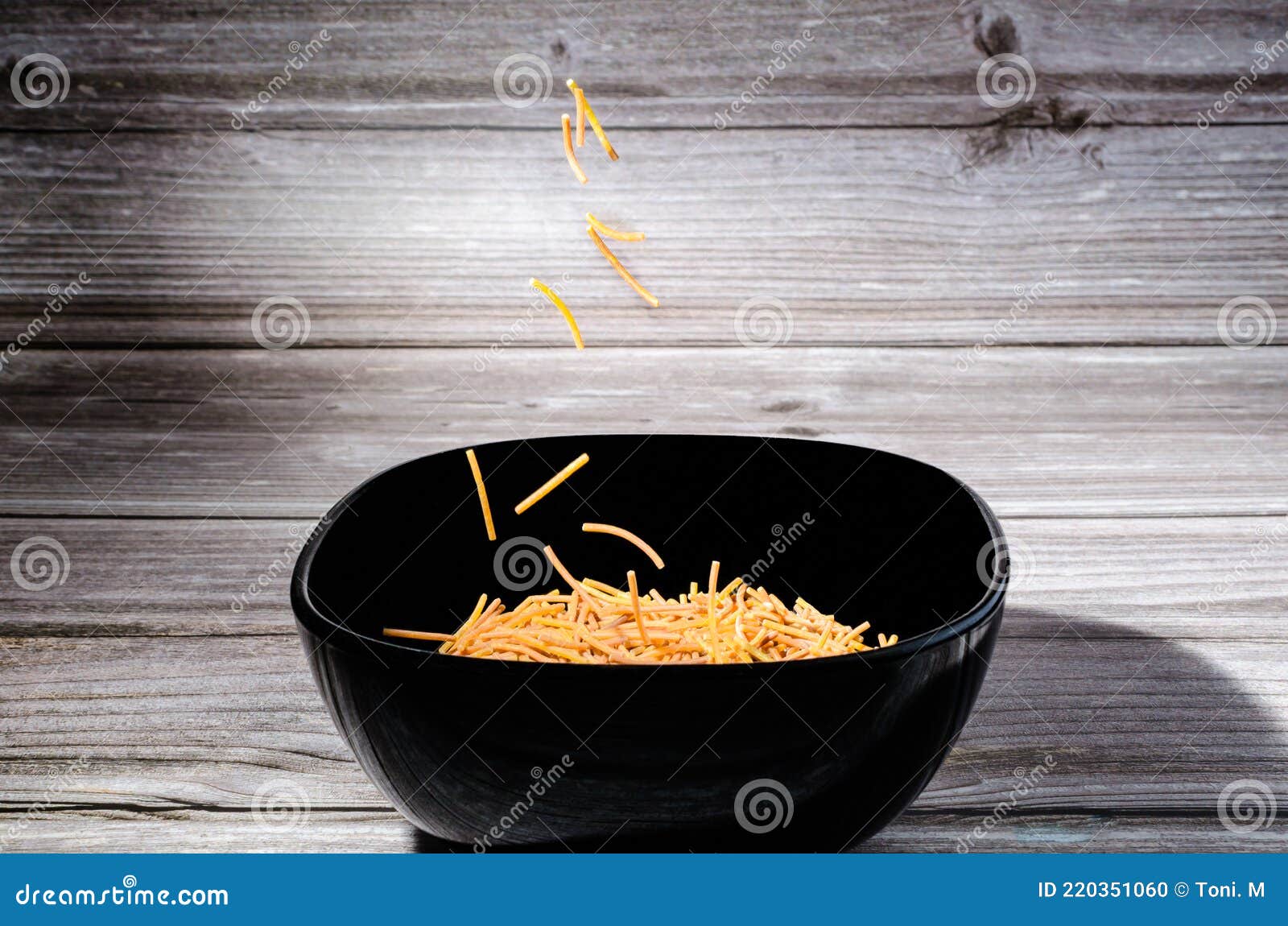 Close-up of Cooked Polyphosphate Noodles Falling into a Black Bowl ...