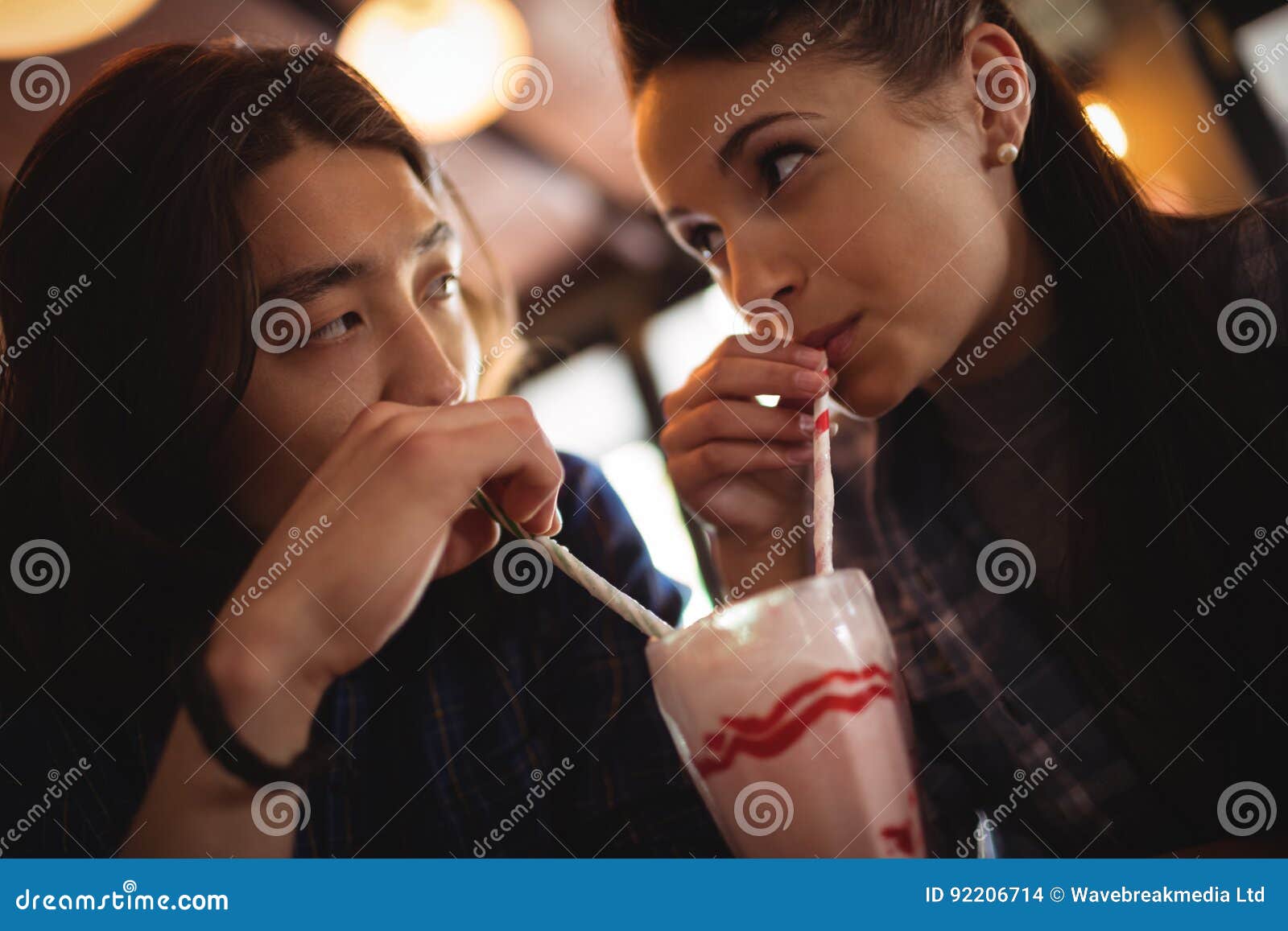 Close-up of Couple Having Milkshake Stock Photo - Image of life ...