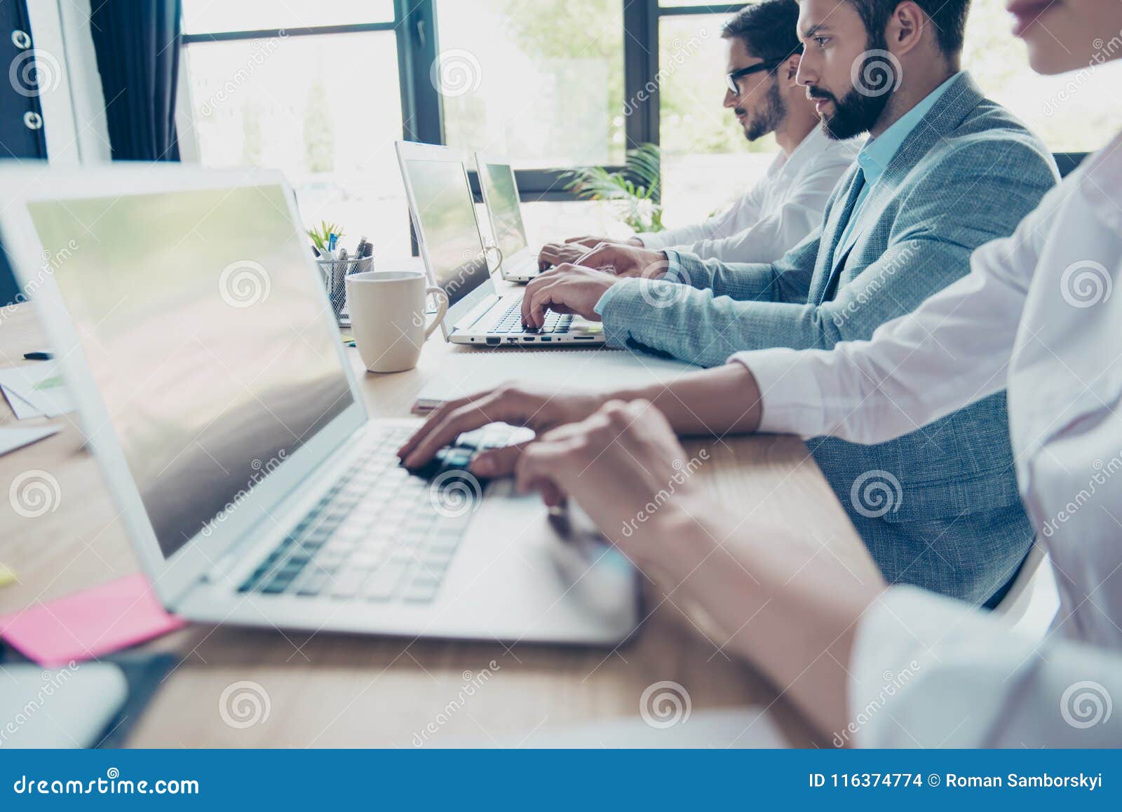 Close Up Cropped Side Profile View of Three Workers Sitting in a Stock ...