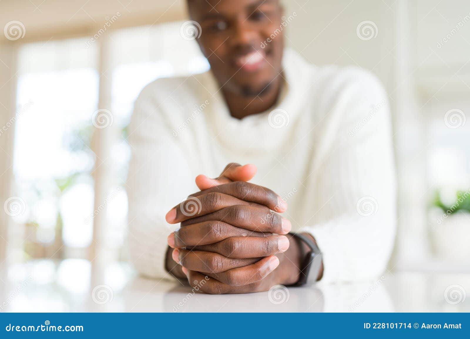 Close Up of Crossed Hands of African Man Over Table Smiling Stock Photo ...