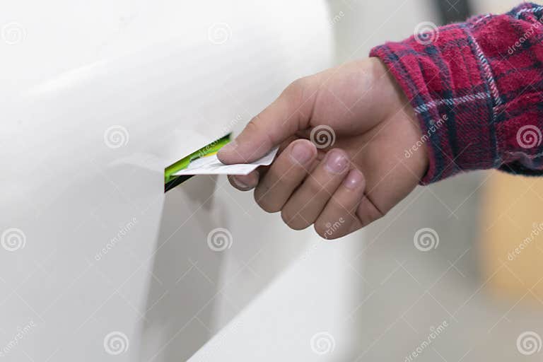 Close Up Customer Hand Pull a Ticket Number from Dispenser Machine To ...