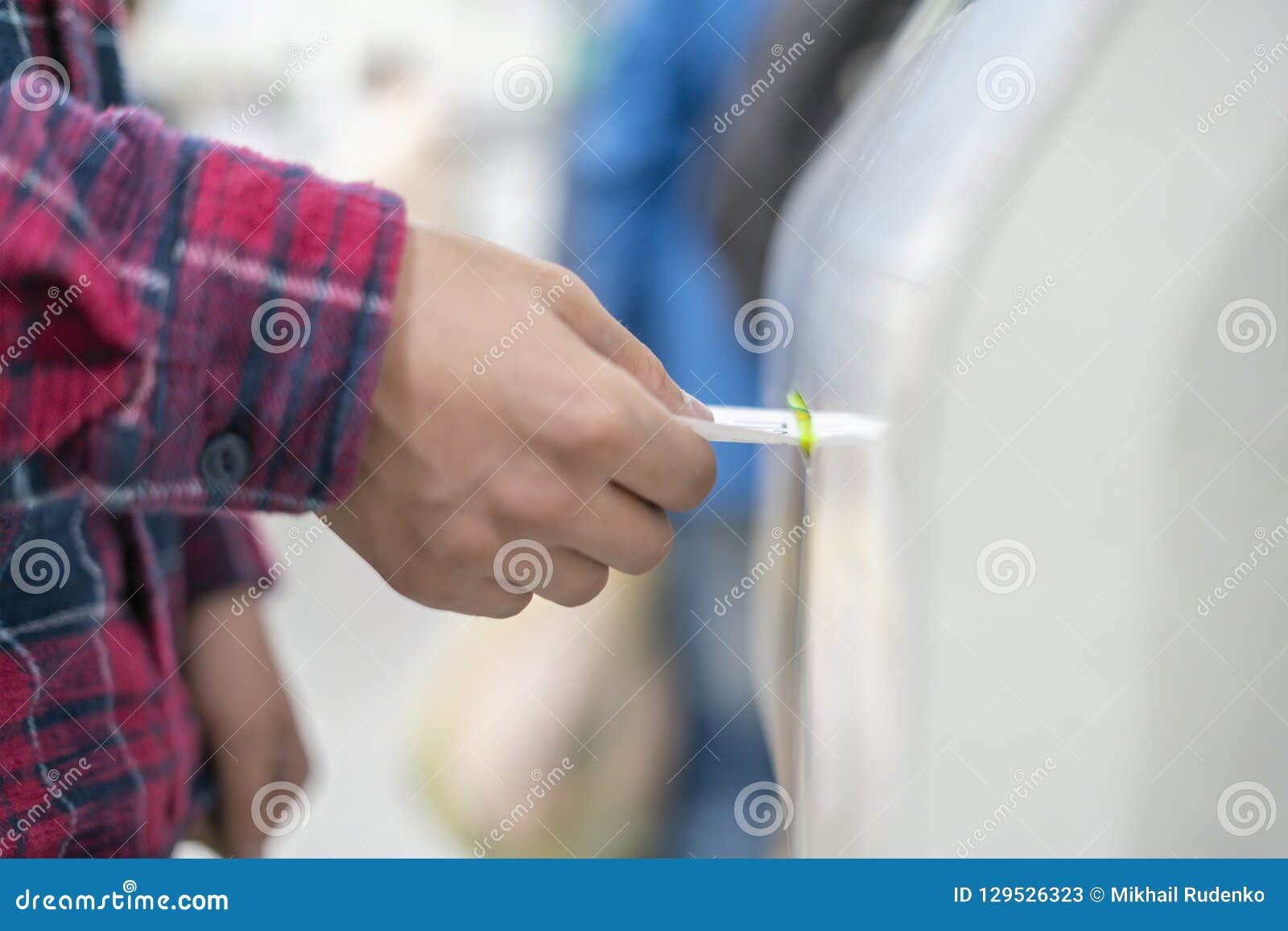 Close Up Customer Hand Pull a Ticket Number from Dispenser Machine To ...