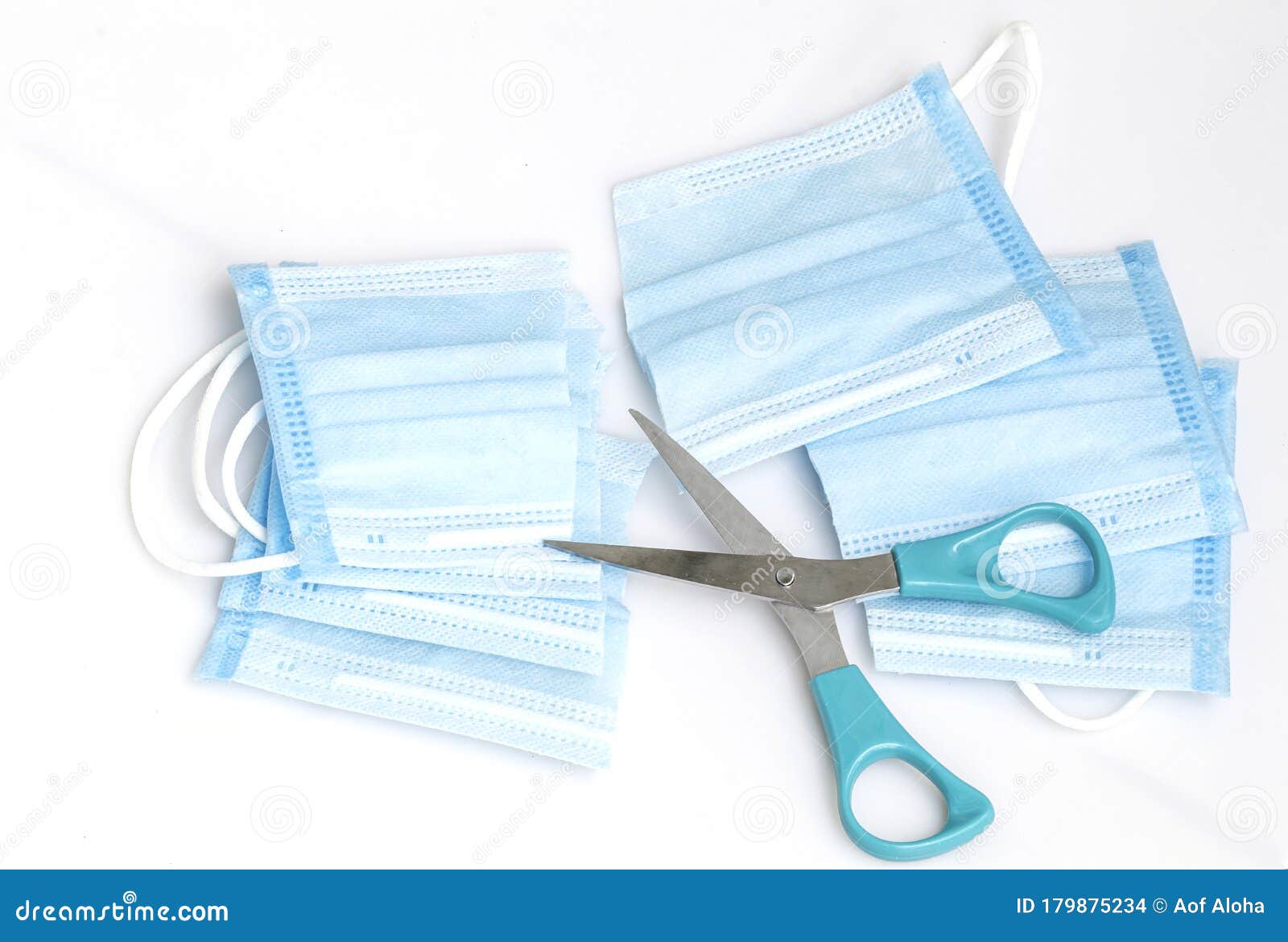 Close-up Cut Face Mask and a Pair of Scissors on White Background.To ...