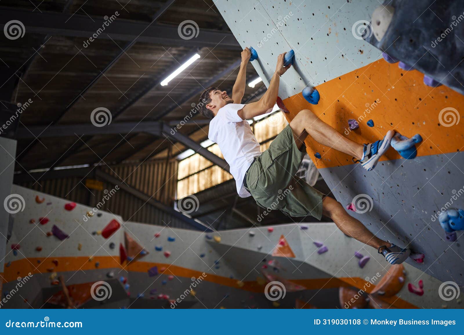 Close Up of Determined Man Tackling Climbing Wall at Indoor Activity ...