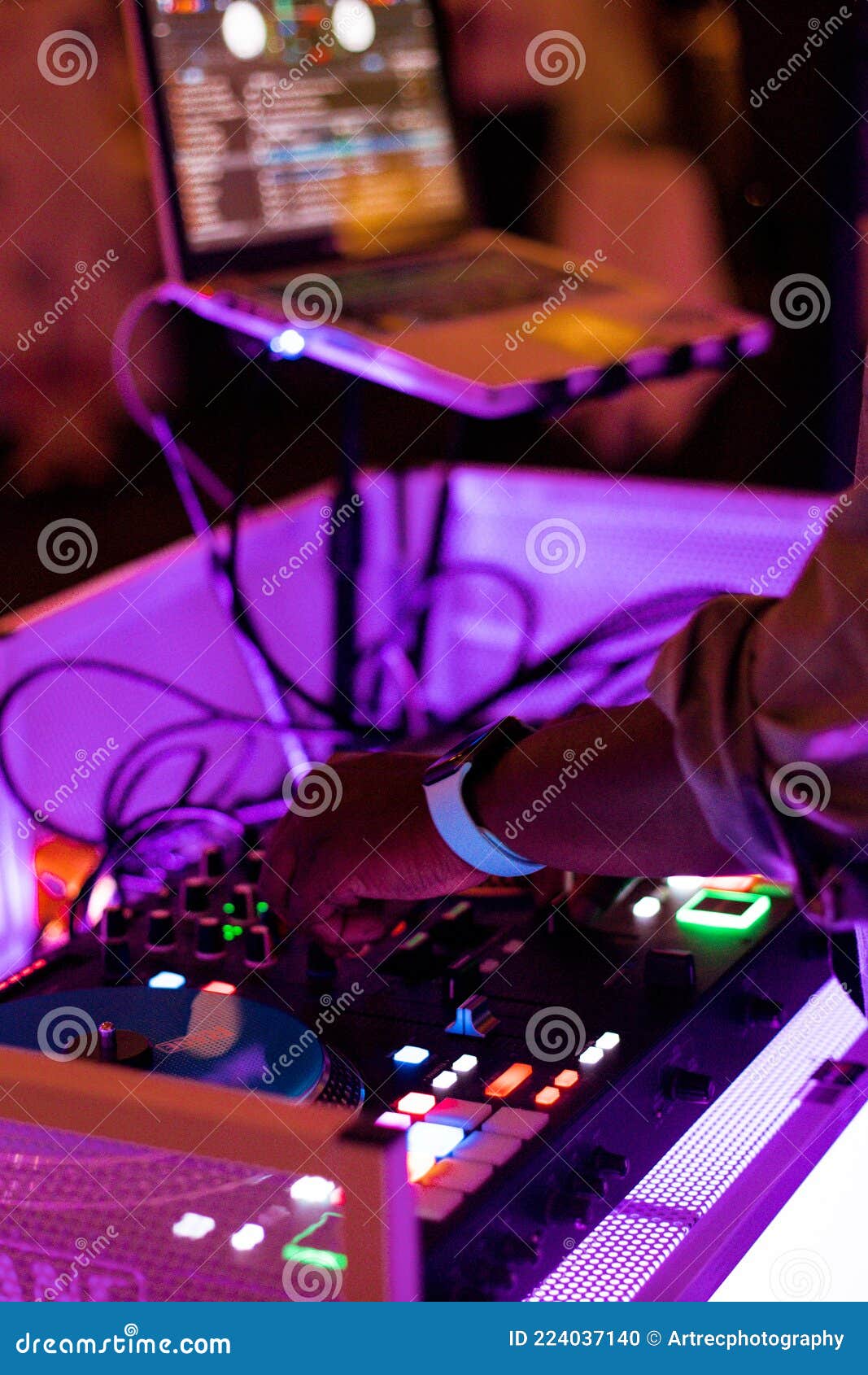 Close Up of DJ Console at the Party. Neon Lights Over the Hands of ...