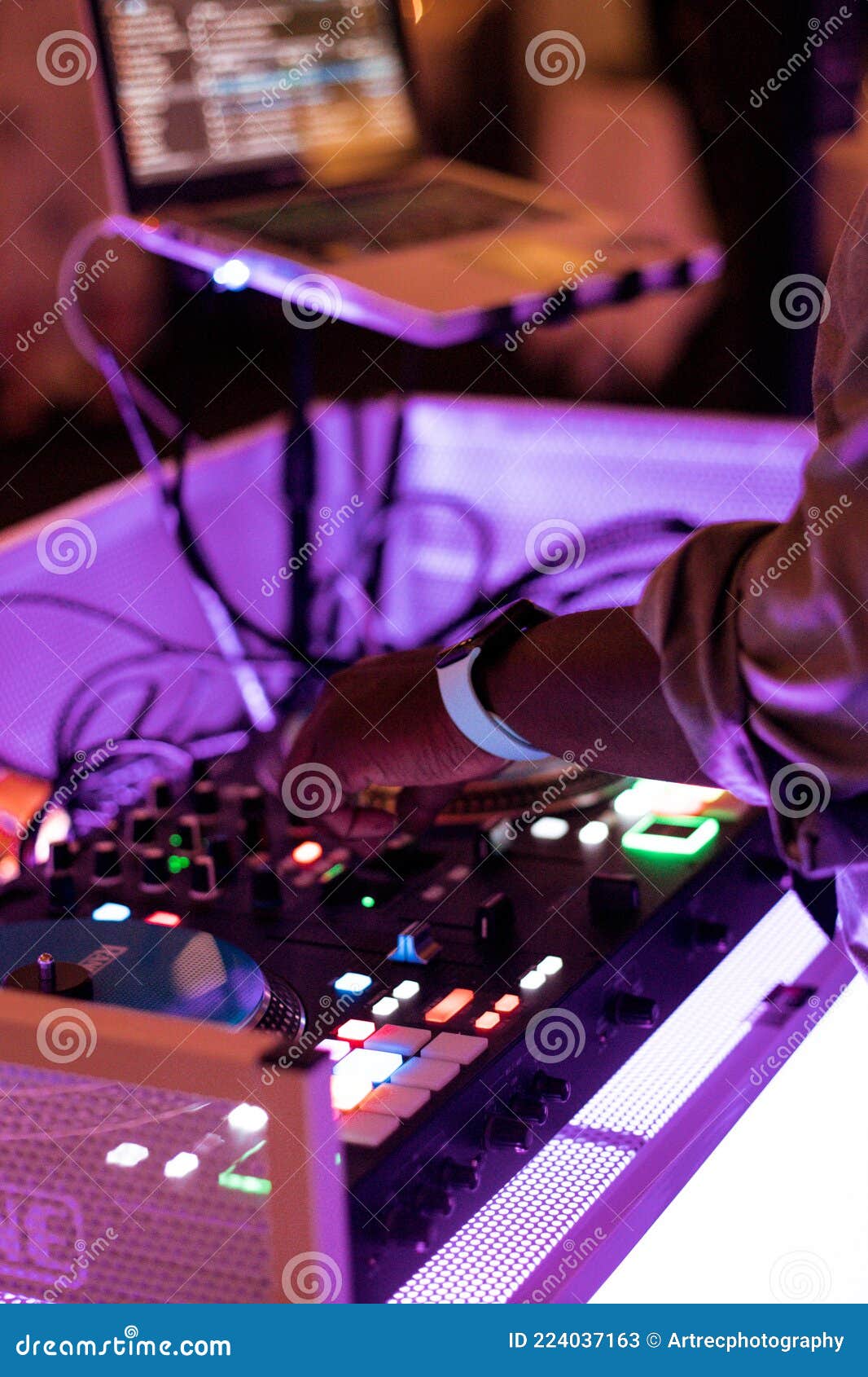 Close Up of DJ Console at the Party. Neon Lights Over the Hands of ...