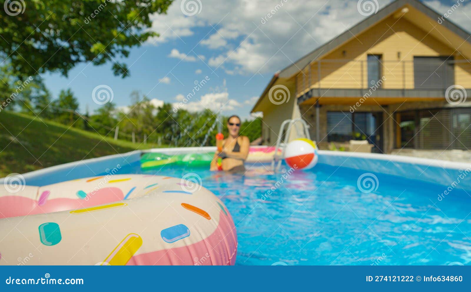 Close Up Happy Woman Squirts Water With Water Gun While Playing In