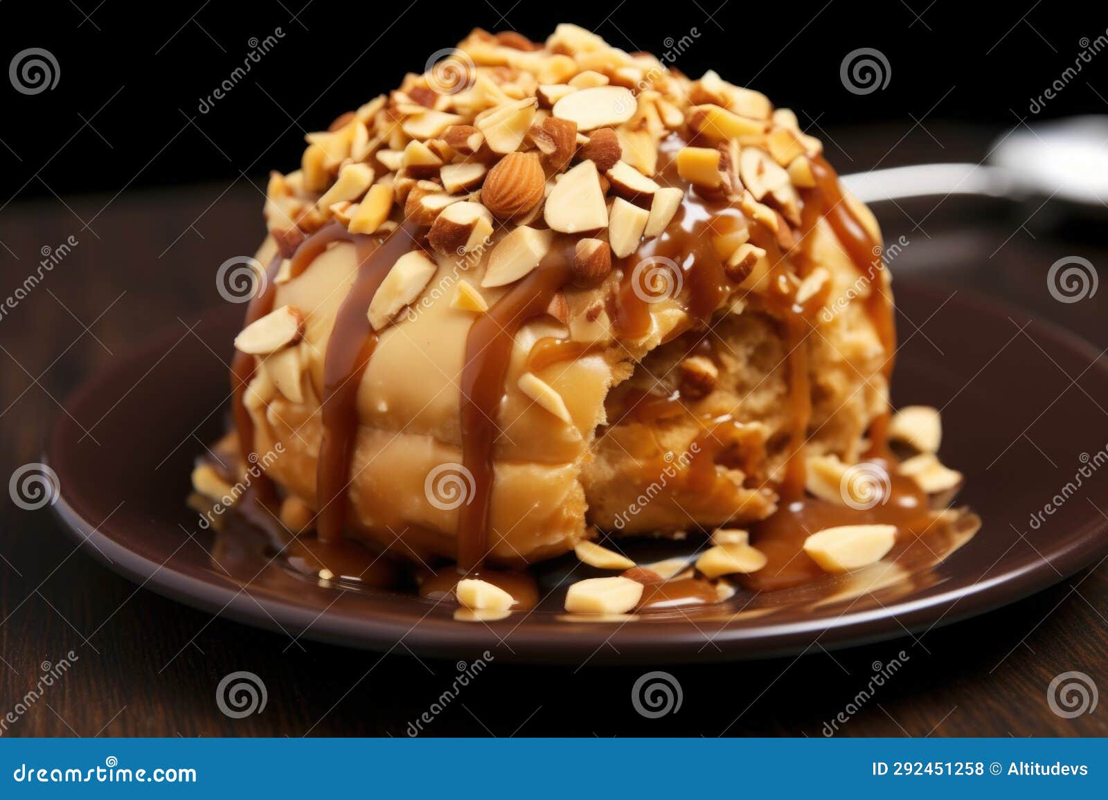 Close-up of a Donut with Caramel Icing and Crushed Nuts Topping Stock ...