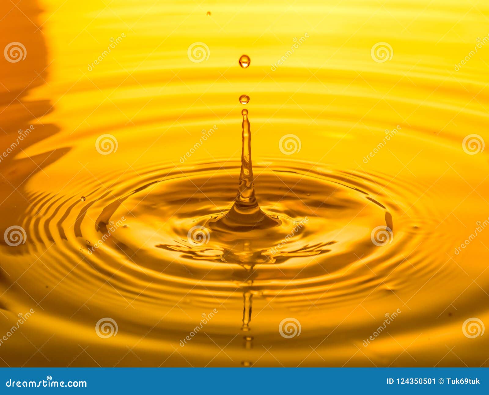 Close Up of a Drop Oil on a Yellow Background Stock Image - Image of ...