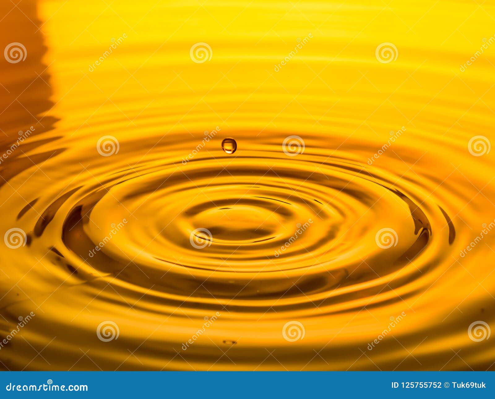 Close Up of a Drop Oil on a Yellow Background Stock Photo - Image of ...