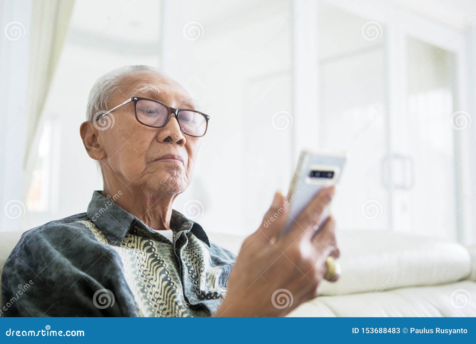 Elderly Man Using a Smartphone at Home Stock Image - Image of hair ...