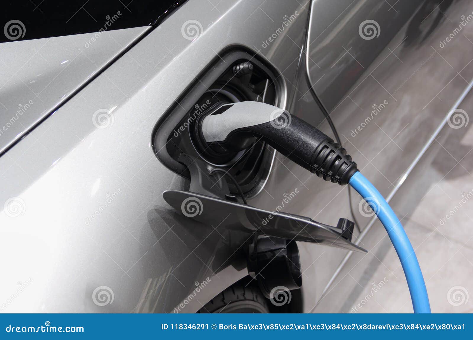 The Close Up of Electric Car Charging Plug, Charging Gray Car Stock ...