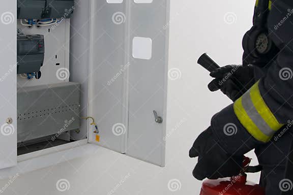 Close-up of an Electrical Switchboard, a Firefighter Holding a Fire ...