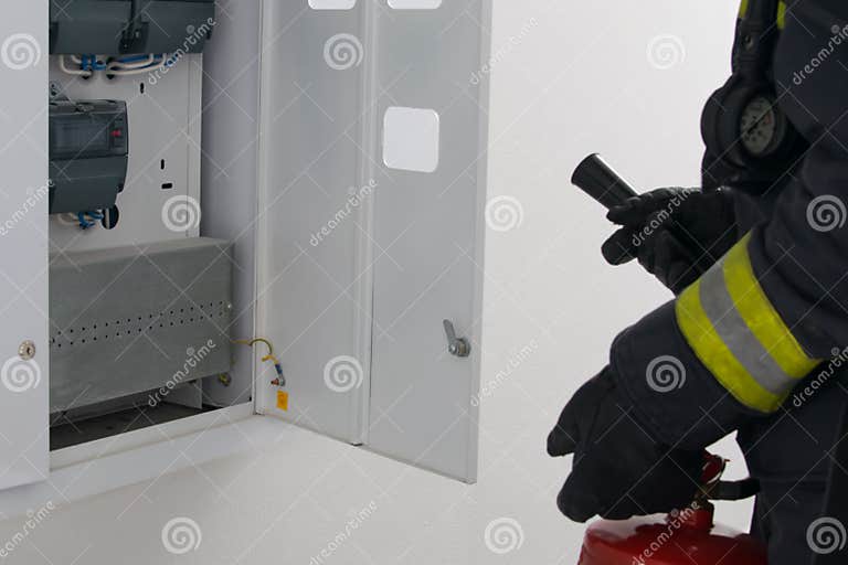Close-up of an Electrical Switchboard, a Firefighter Holding a Fire ...