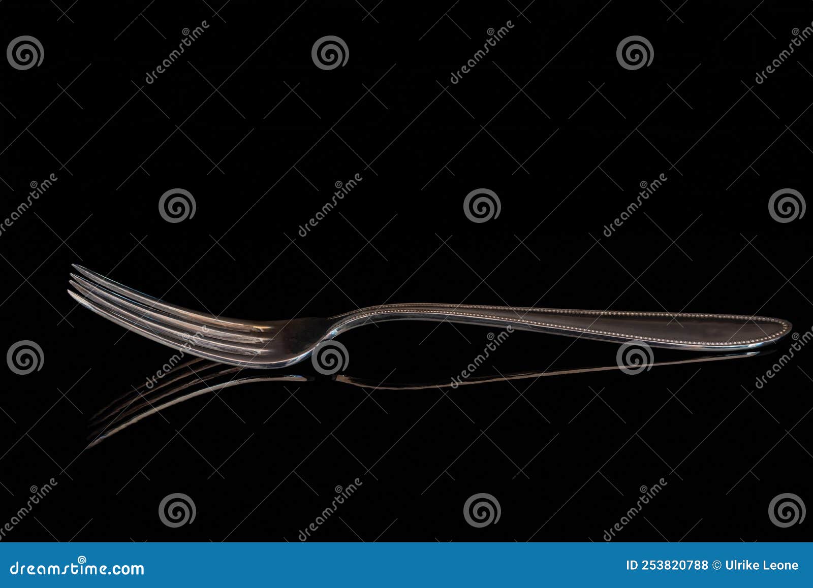 Close-up of an Empty Old Fork with Long Tines Reflected Against a Dark ...
