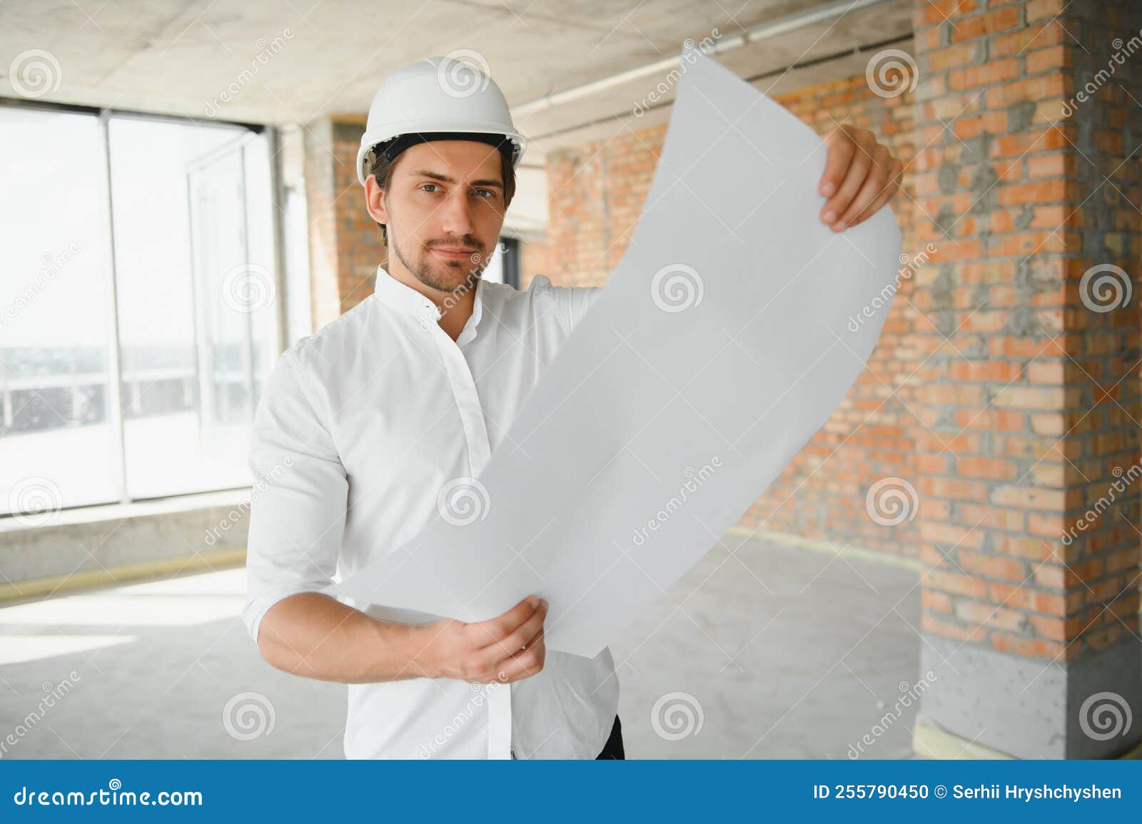 Close Up Engineers Working on a Building Site Holding a Blueprints ...