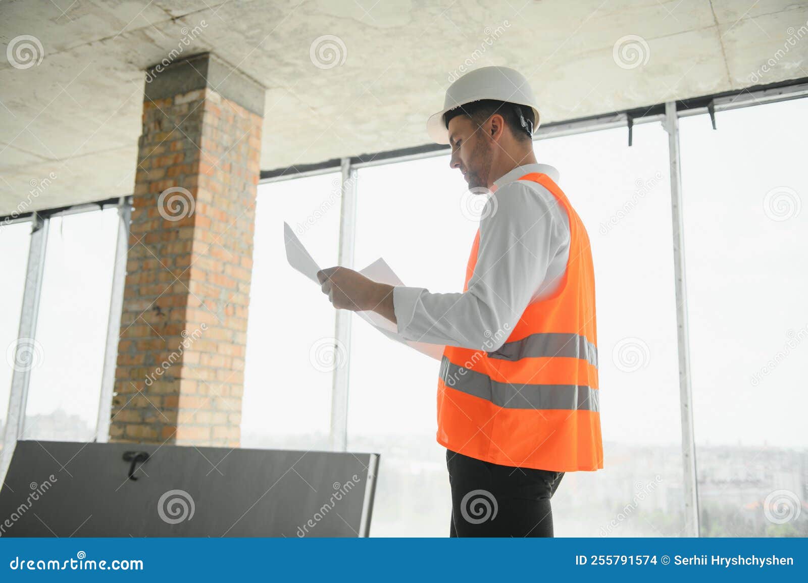 Close Up Engineers Working on a Building Site Holding a Blueprints.Engineering and Architecture ...