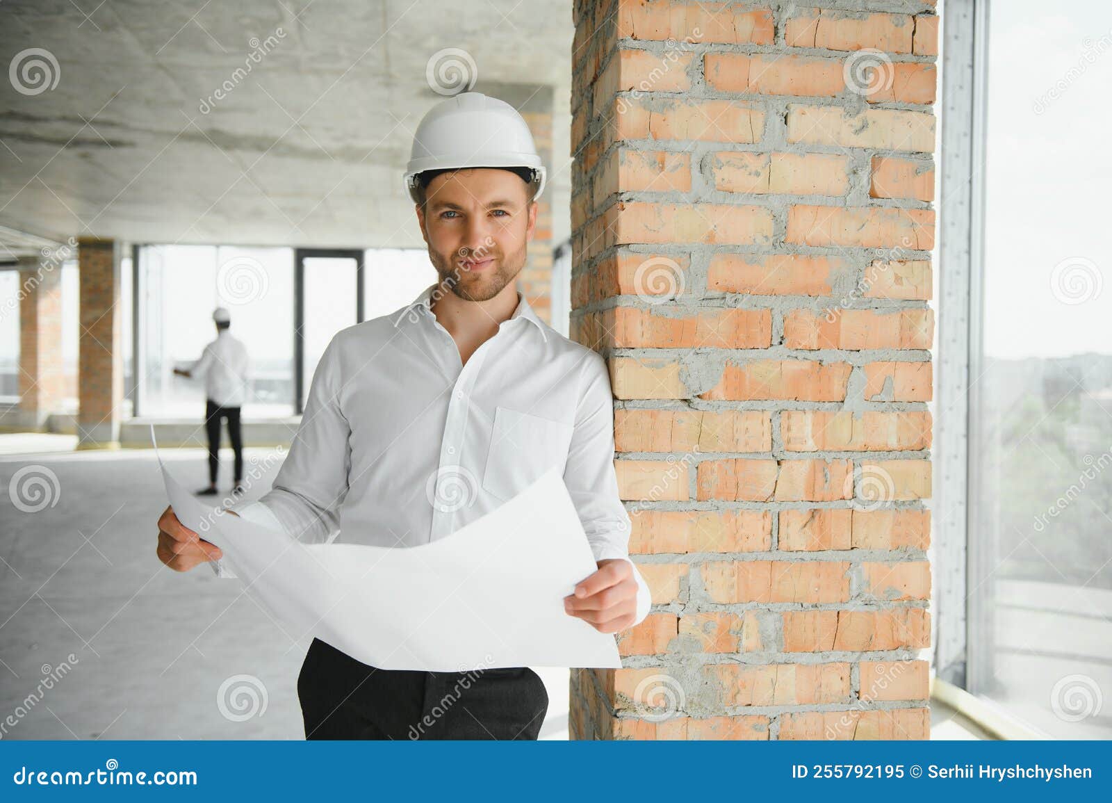 Close Up Engineers Working on a Building Site Holding a Blueprints ...