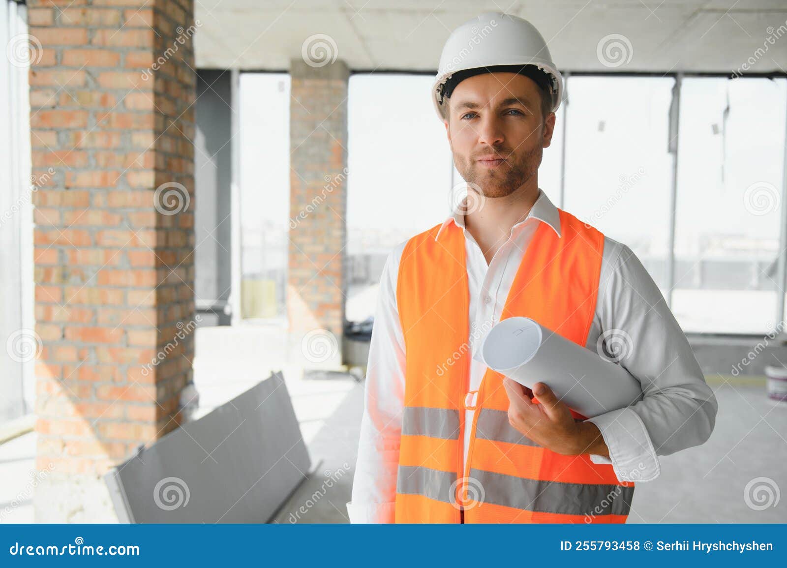 Close Up Engineers Working on a Building Site Holding a Blueprints ...