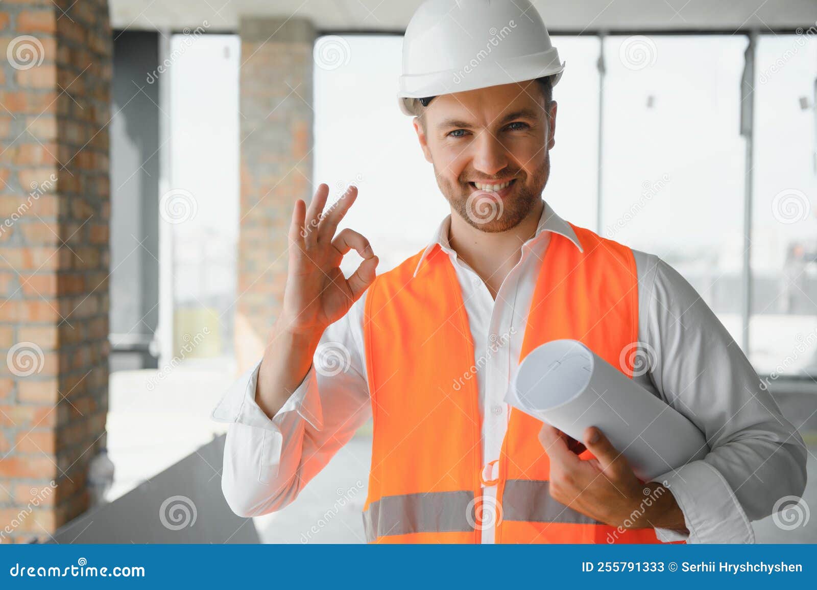 Close Up Engineers Working on a Building Site Holding a Blueprints ...