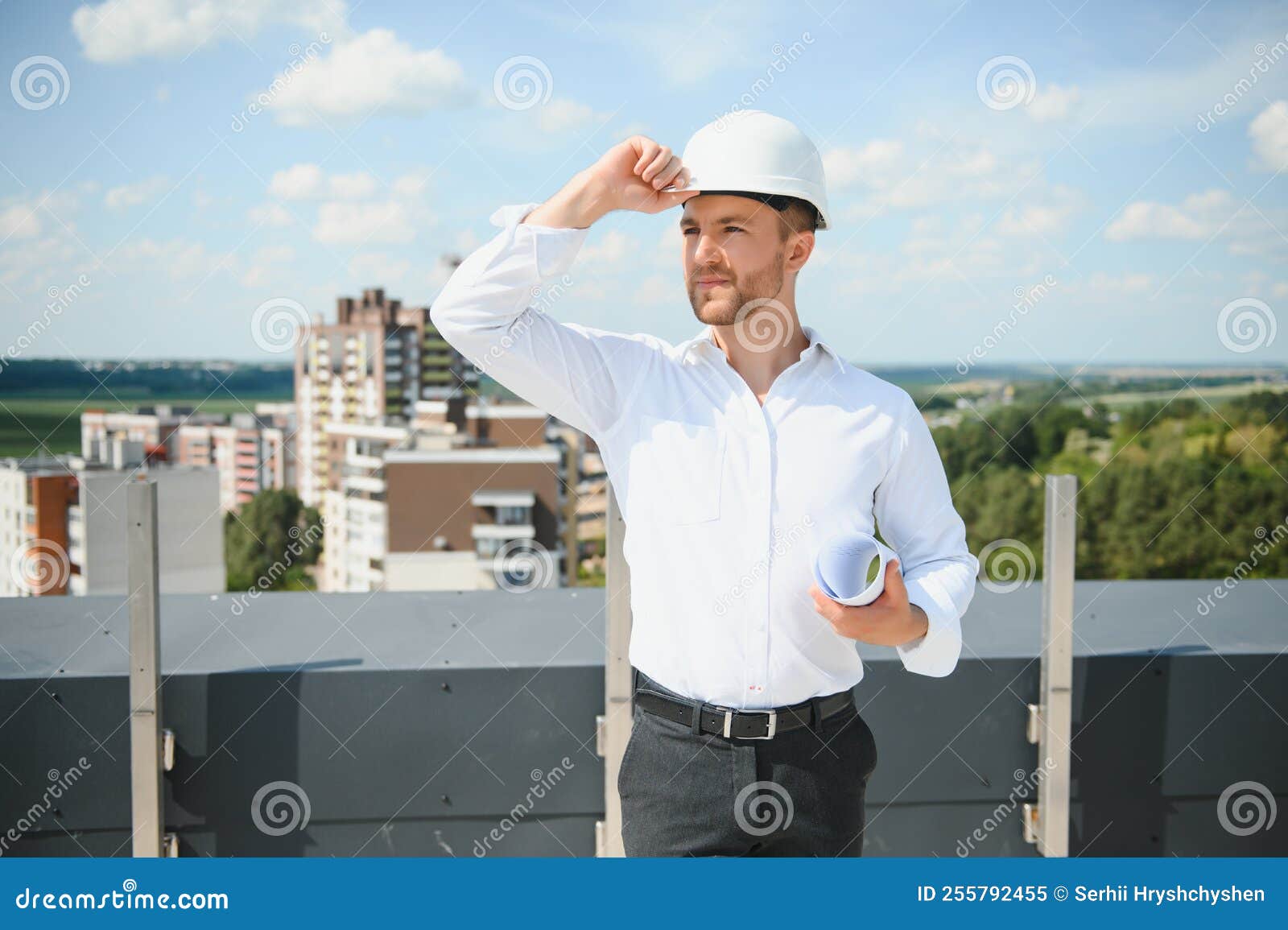 Close Up Engineers Working on a Building Site Holding a Blueprints ...