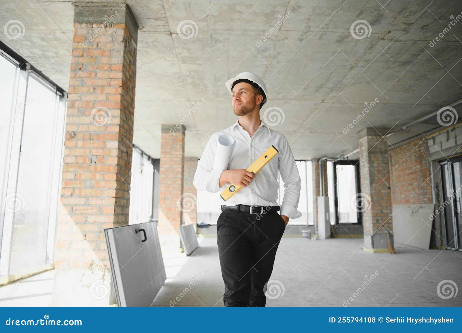 Close Up Engineers Working on a Building Site Holding a Blueprints ...