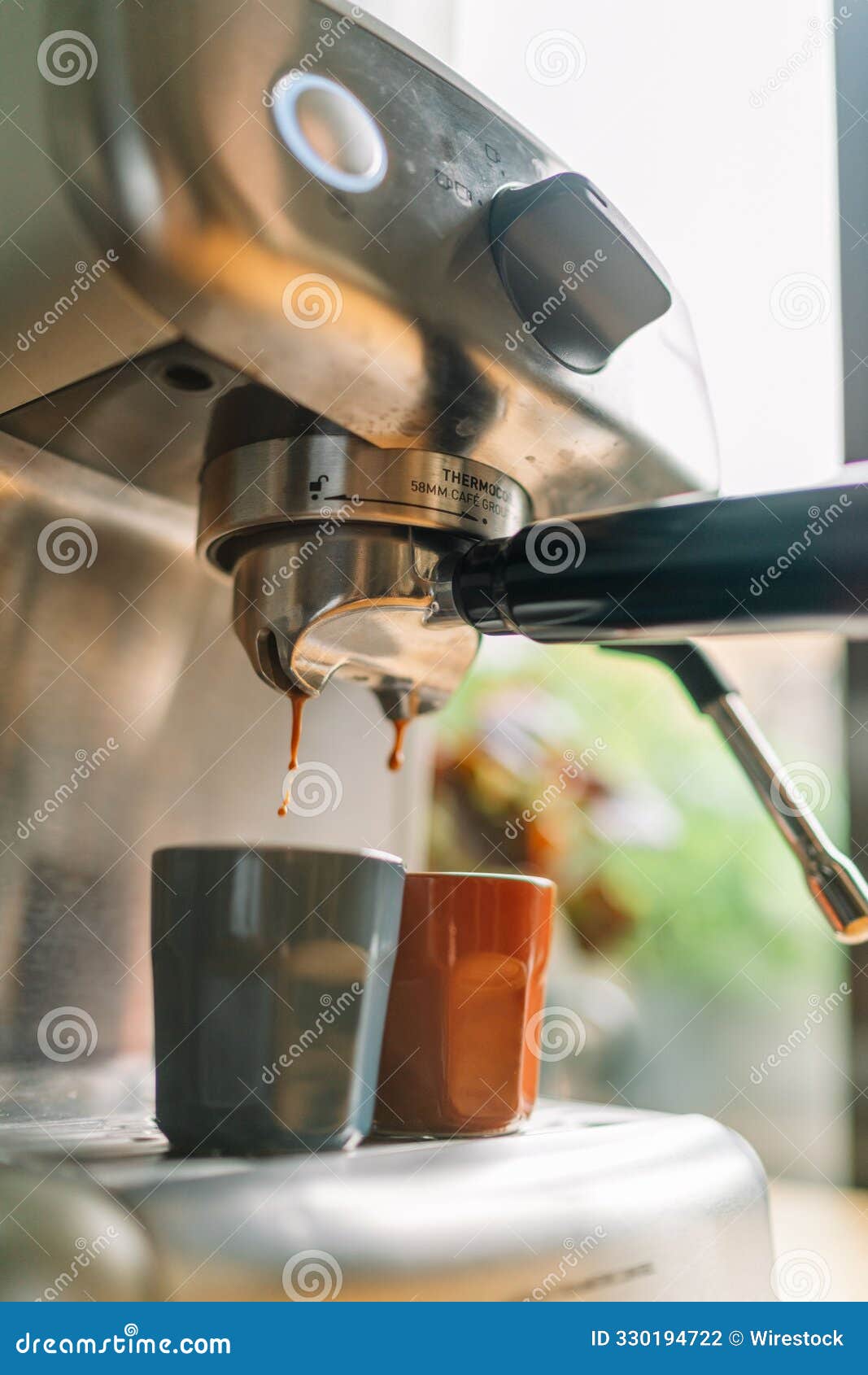 Close-up of an Espresso Machine Brewing Coffee into Two Colorful Cups ...