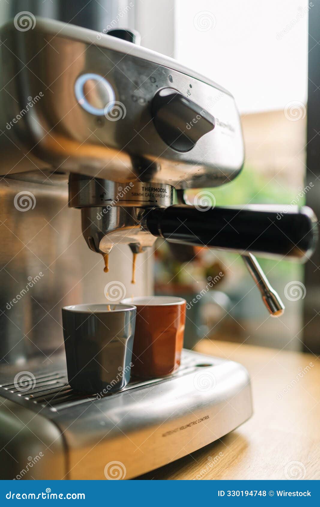 Close-up of an Espresso Machine Brewing Coffee into Two Cups in a Cozy ...