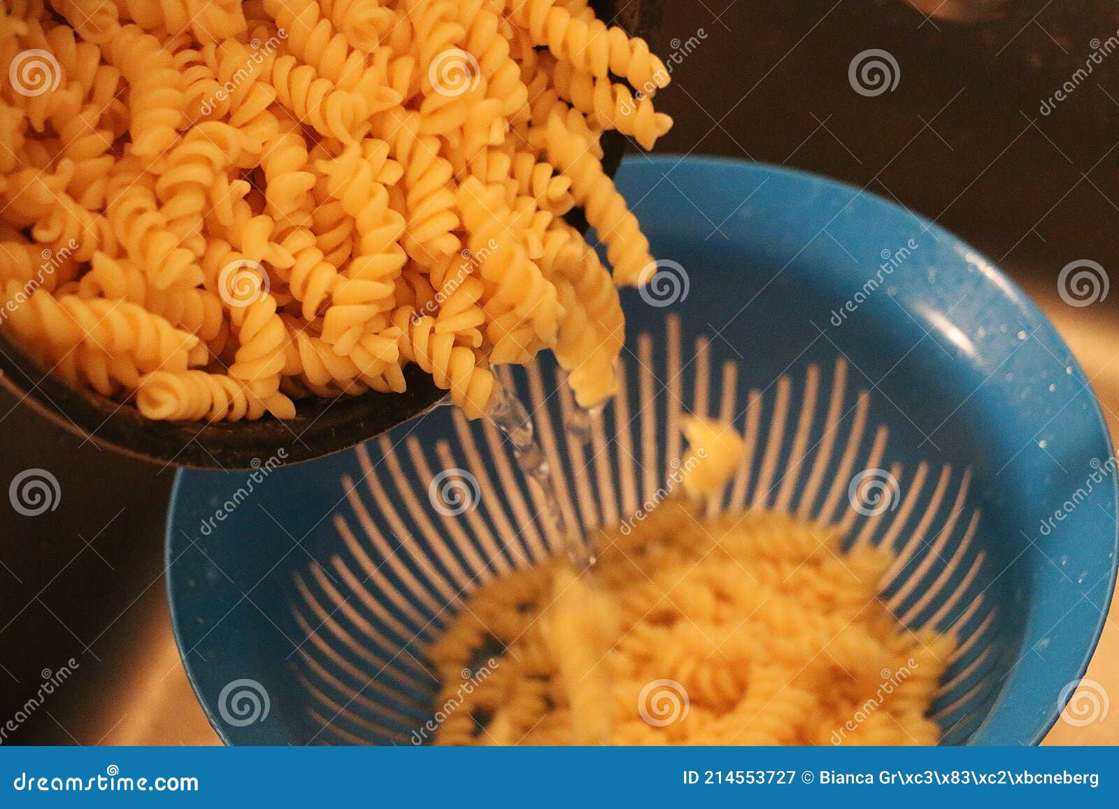 A Close Up of Falling Spiral Noodles in a Sieve Stock Image - Image of ...