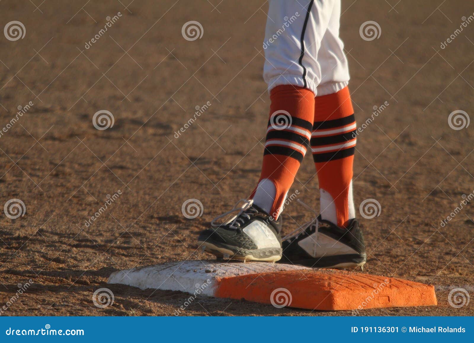 Baseball Player Standing on First Base Stock Image - Image of outdoors ...