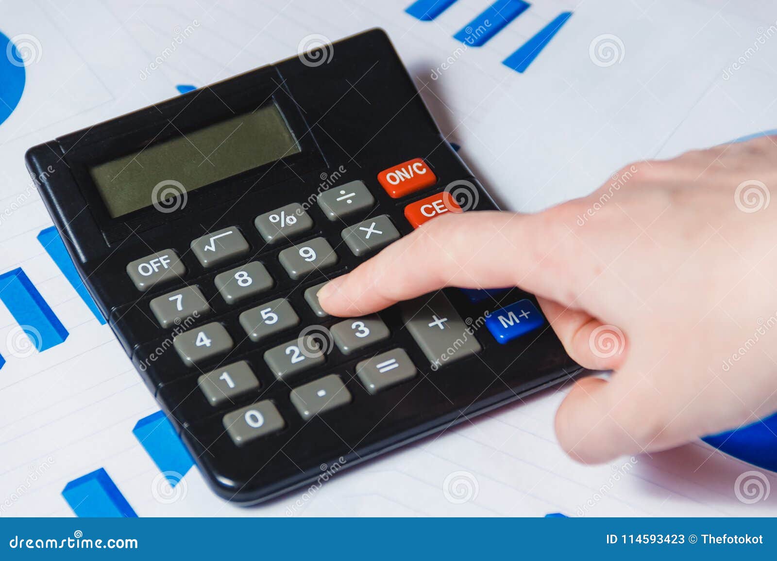 Close-up of Female`s Hand Using Calculator on Desk with Diagram. Stock ...