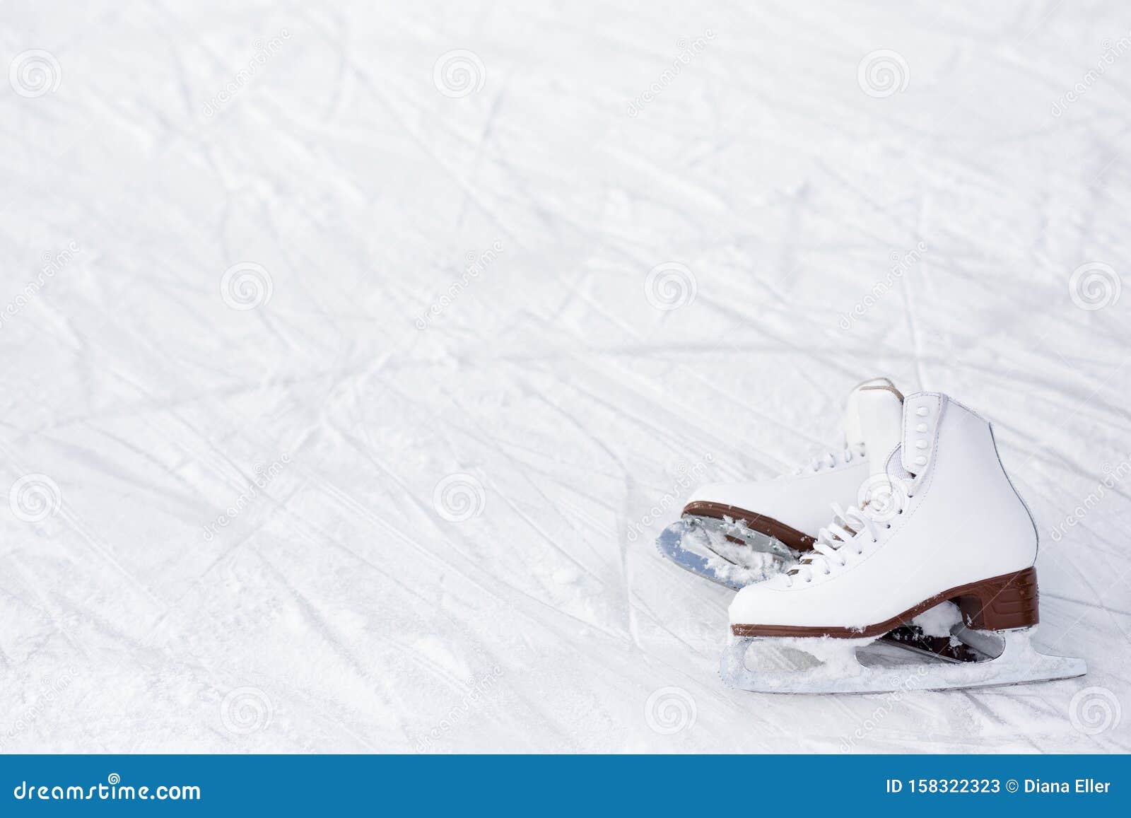 Close Up of Figure Skates and Copy Space Over Ice with Marks from ...