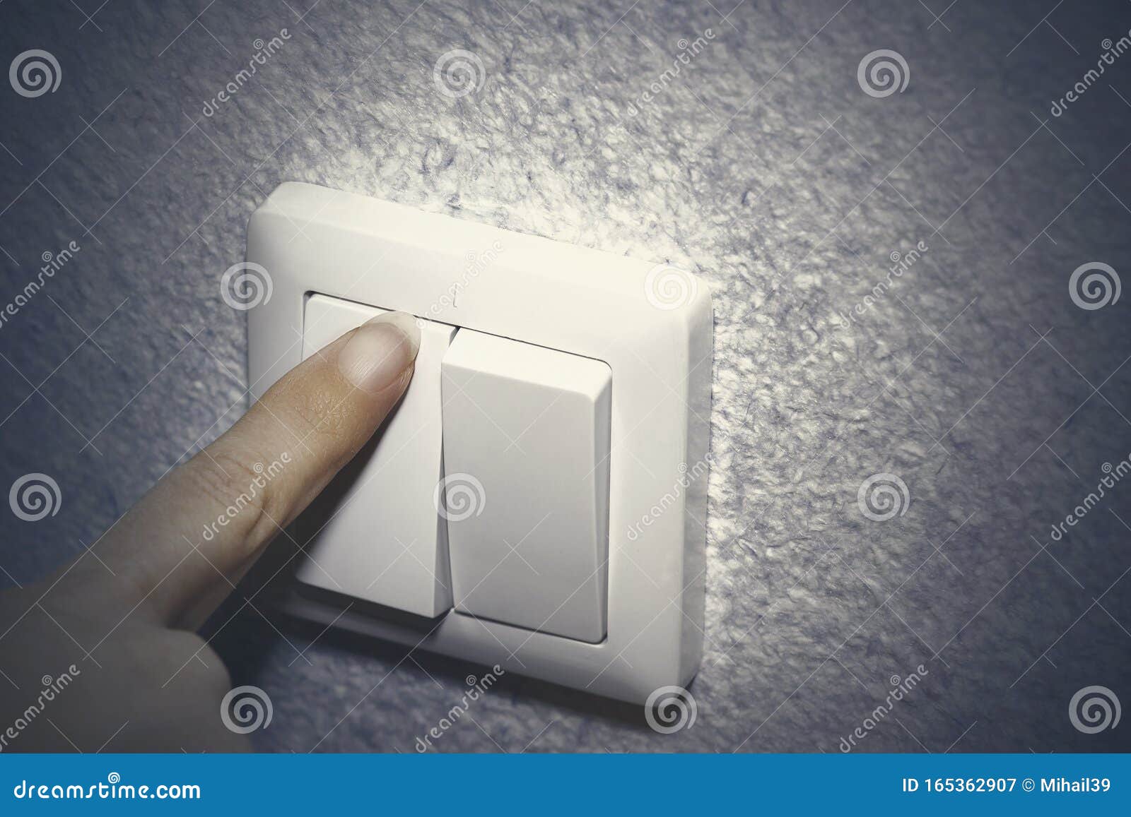 Close Up. a Finger Presses Down on a Single White Light Switch on a ...