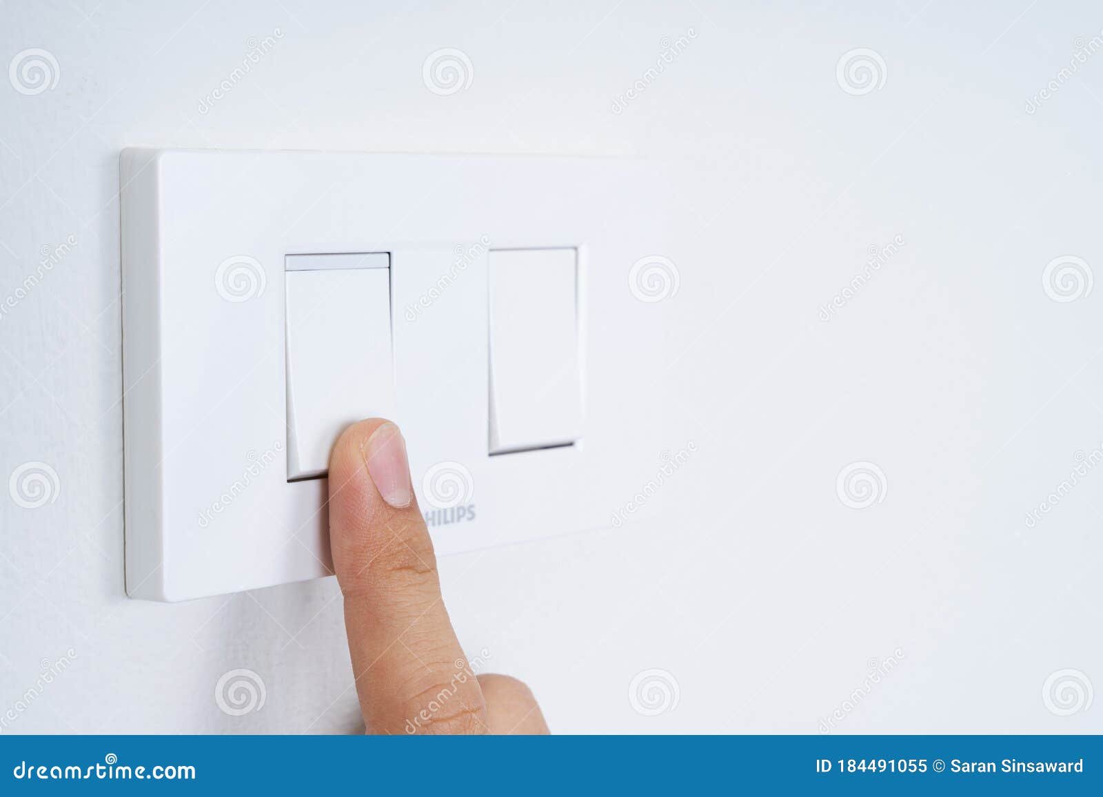 Close Up Finger Turn on or Off on White Light Switch with White Wall at ...