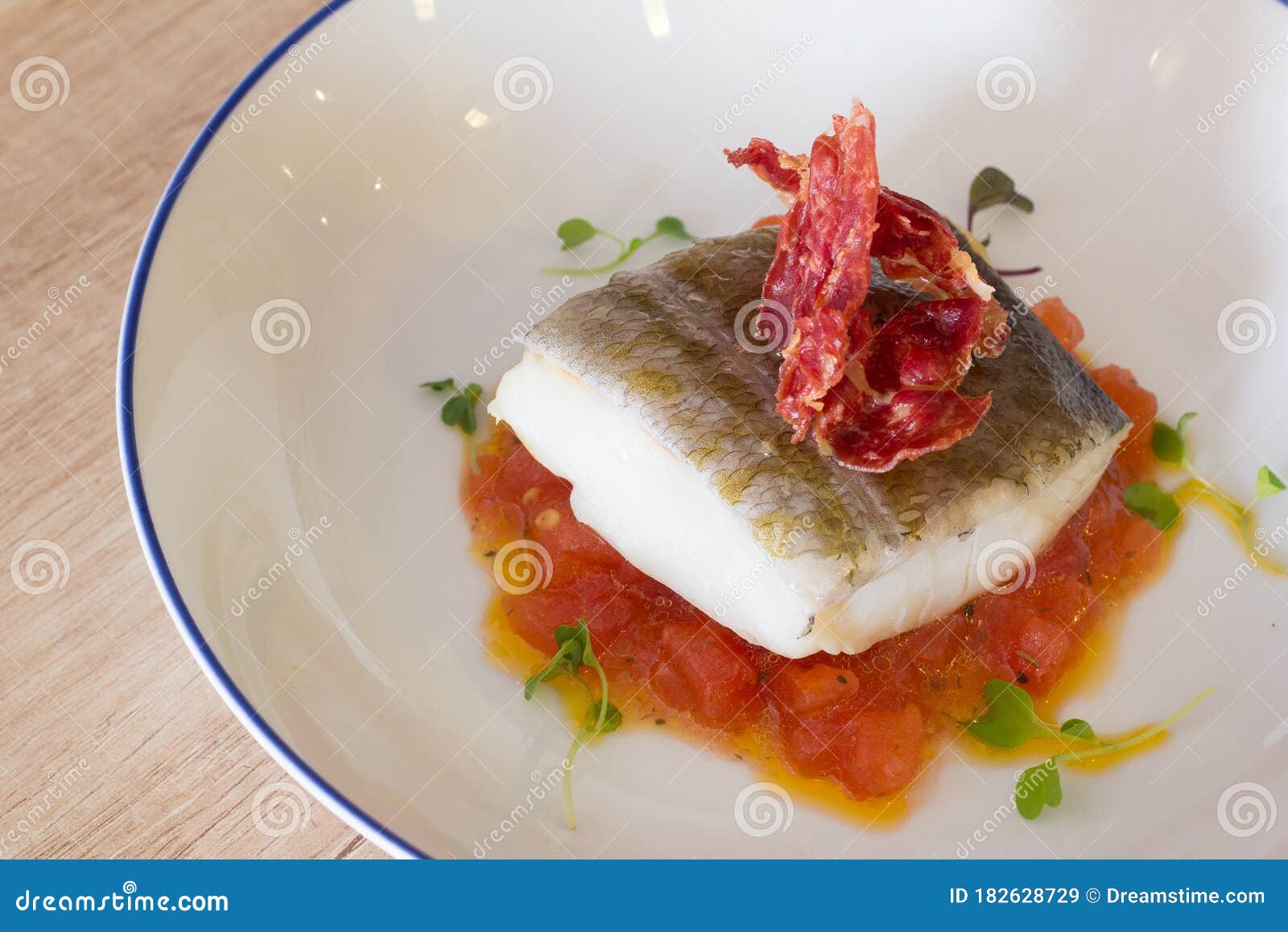 Close-up of Fish Dish, Cod with Tomato, Served on a Rustic Plate Stock ...