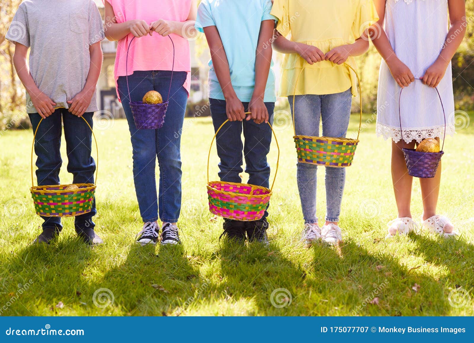 Close Up of Five Children Holding Baskets on Easter Egg Hunt in Garden ...