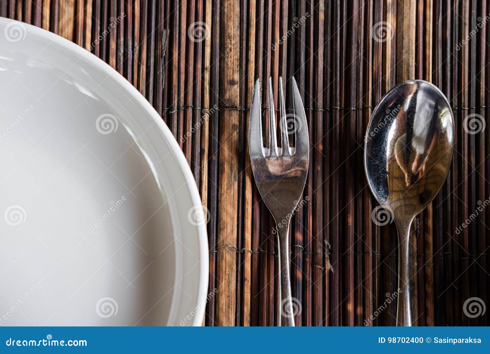 Close-up Fork with Spoon and White Dish on Wooden Tablemat Stock Photo ...