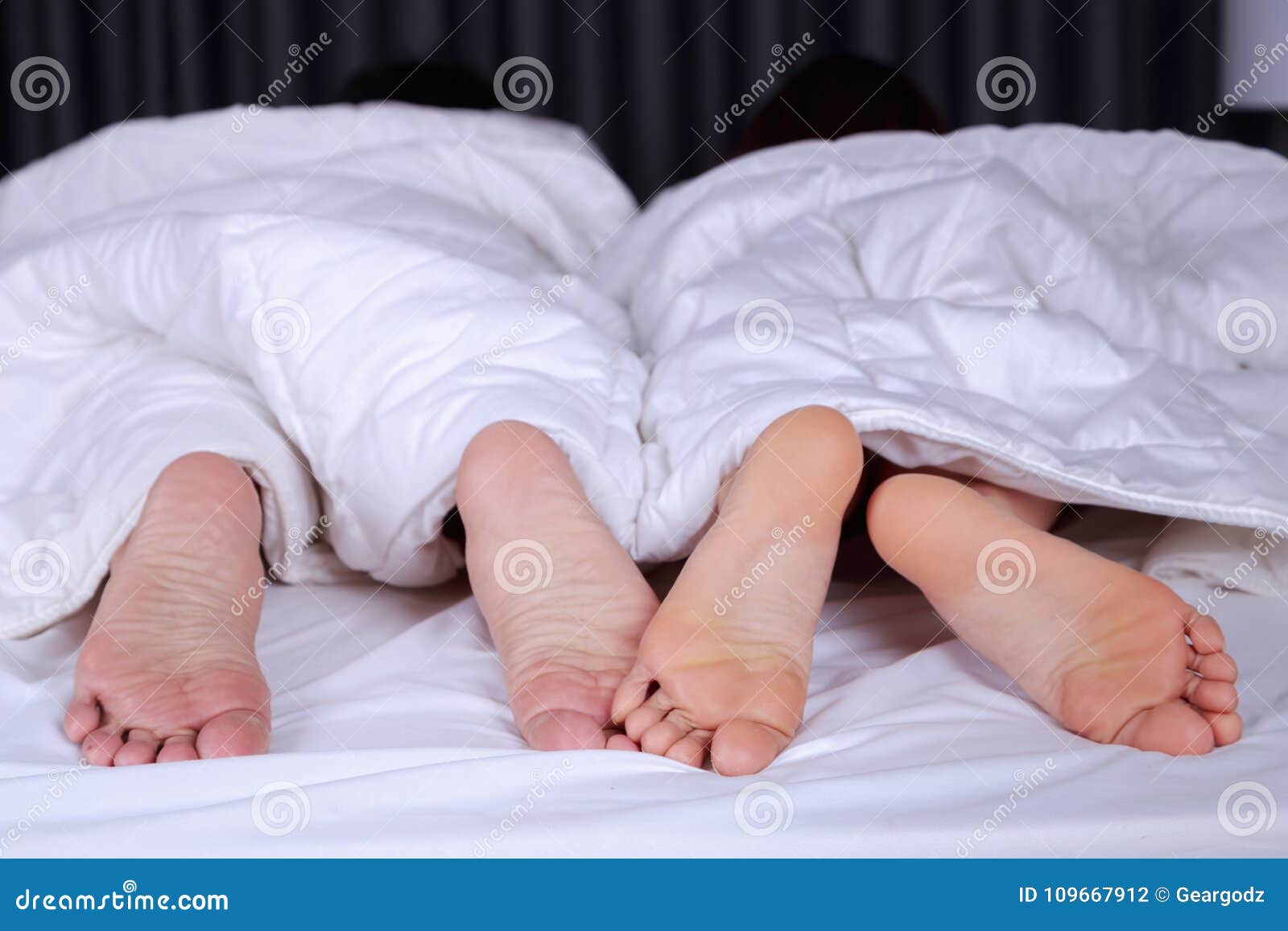 Close Up of Four Feet in Bed Stock Photo - Image of family, bedroom ...